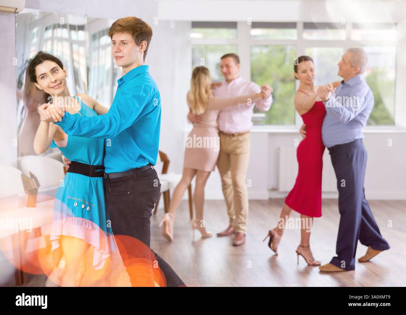 Woman learning to dance waltz with young partner in dancing class Stock ...