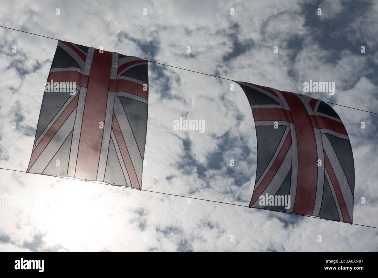 Union Jack flags fly from lines above the city Stock Photo - Alamy
