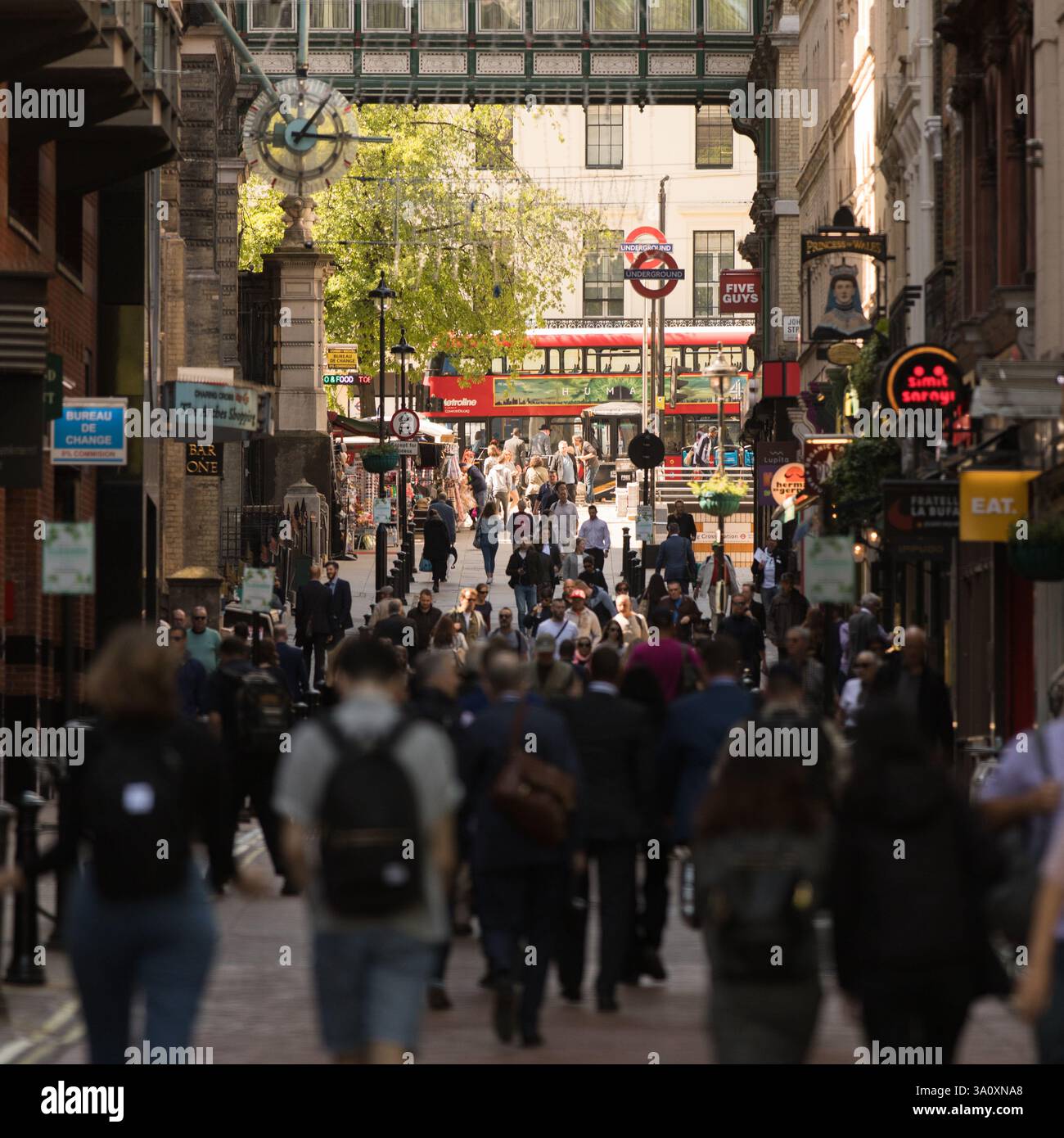 Busy pedestrian street scene in London's Charing Cross, near the Arches ...