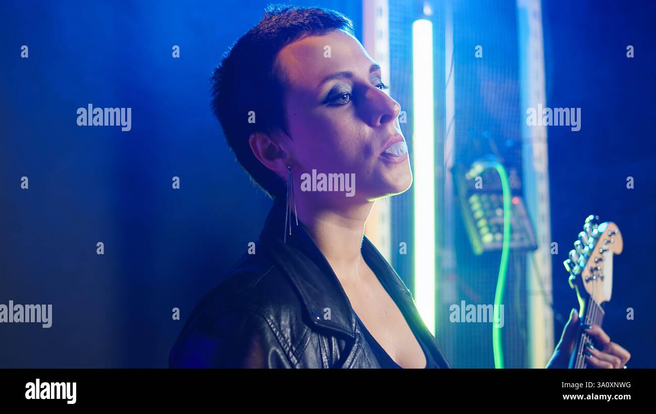 Female rock star blowing bubbles from chewing gum at nightclub, acting ...