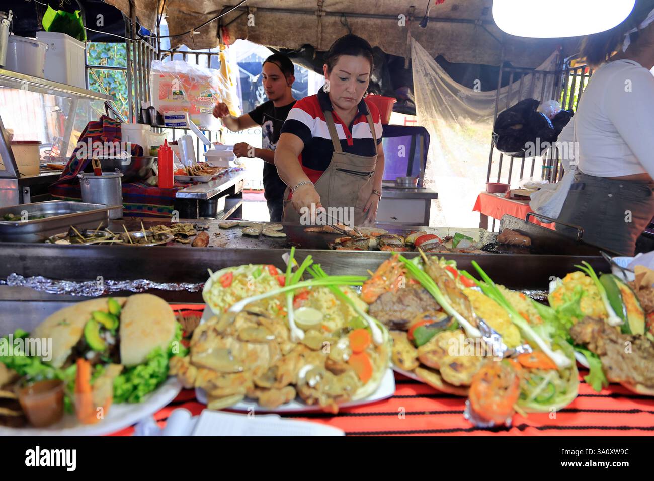 A female food vendor cooking at weekend Juayua Food Festival.Juayua ...