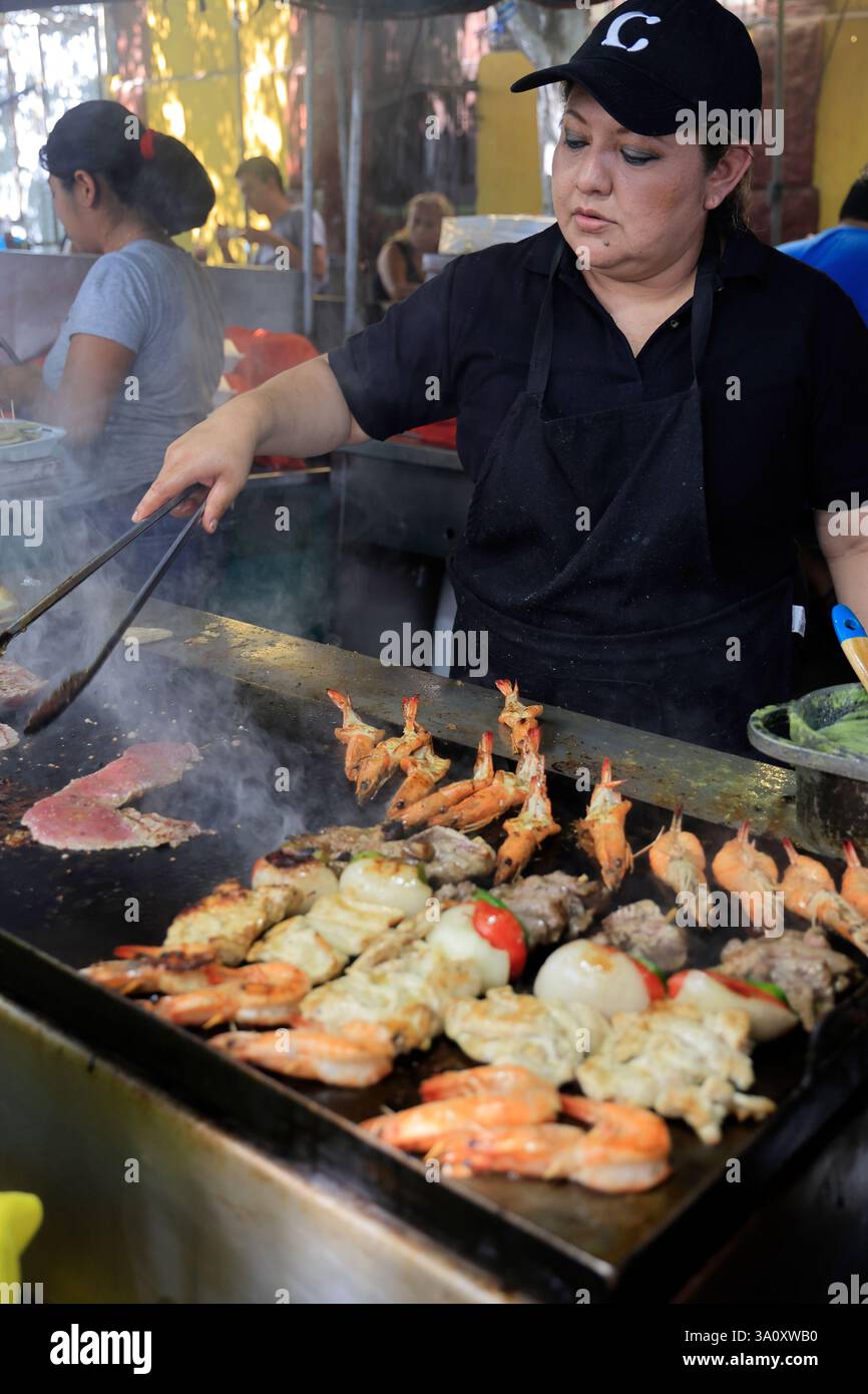A female food vendor cooking at weekend Juayua Food Festival.Juayua ...