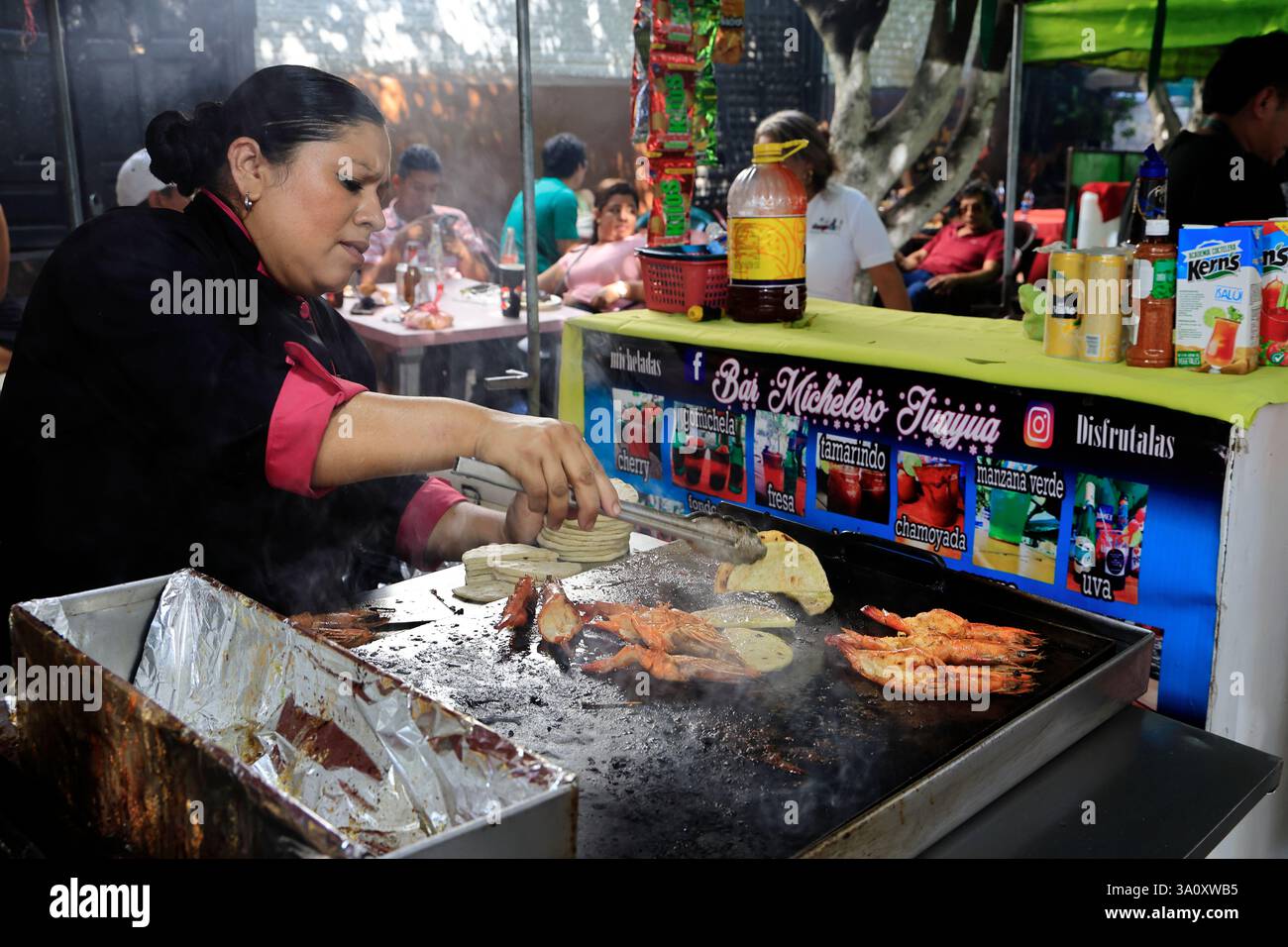 A female food vendor cooking at weekend Juayua Food Festival.Juayua ...