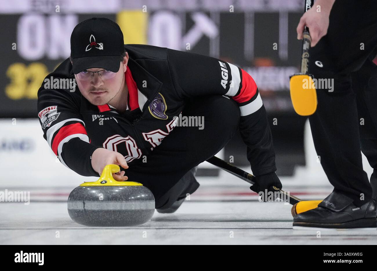 Ontario skip Sam Mooibroek delivers a rock while playing Alberta-Jacobs ...
