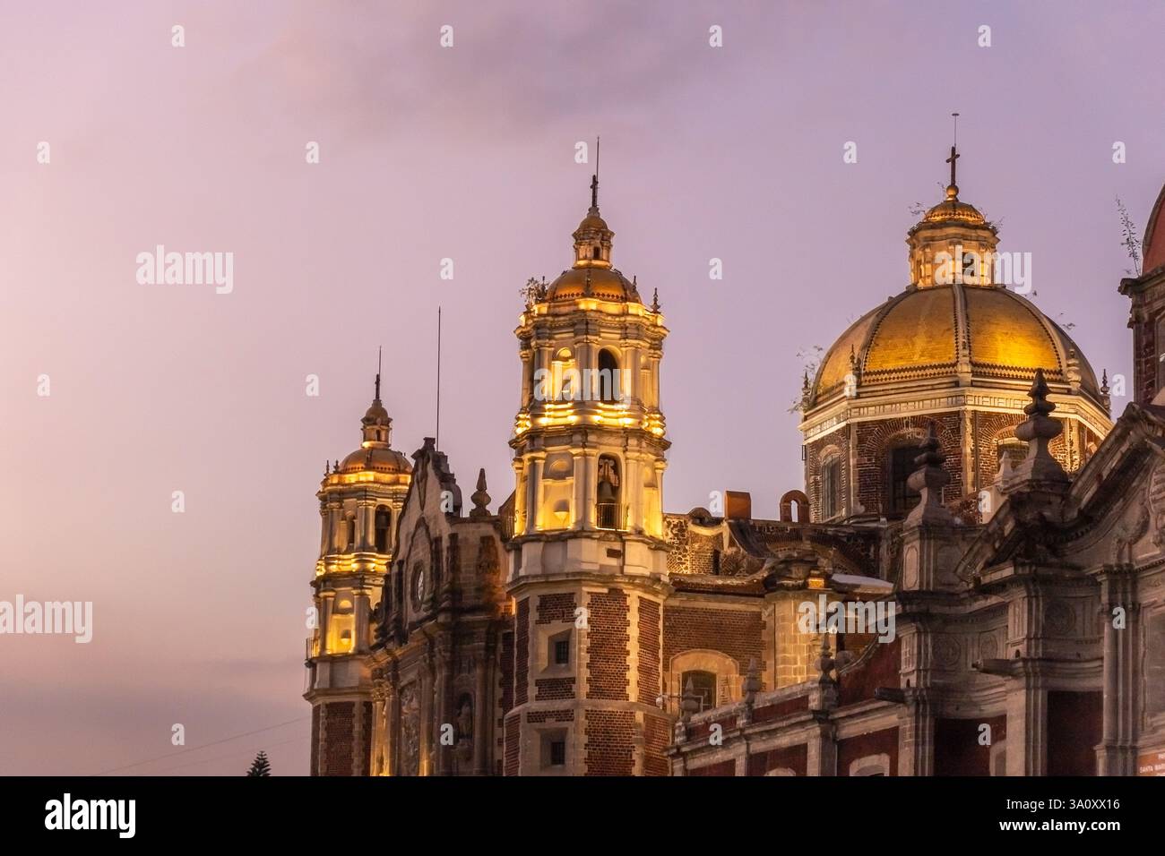 The historic Basilica Antigua of Guadalupe glows at dusk, showcasing ...