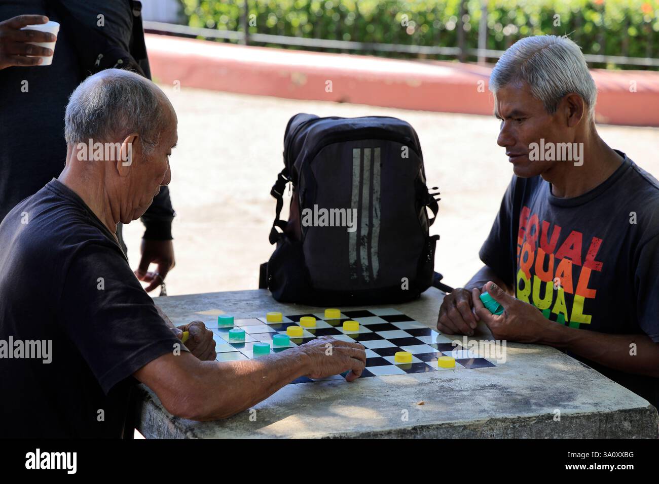 Men playing checkers game in Parque Central de Granada (Granada Central ...