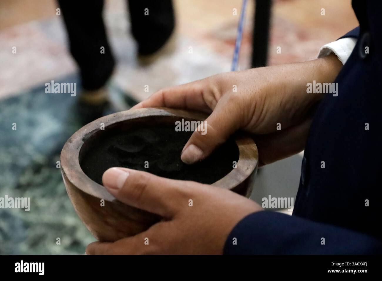 A nun holds ashes during a mass at Catedral Metropolitana where ...
