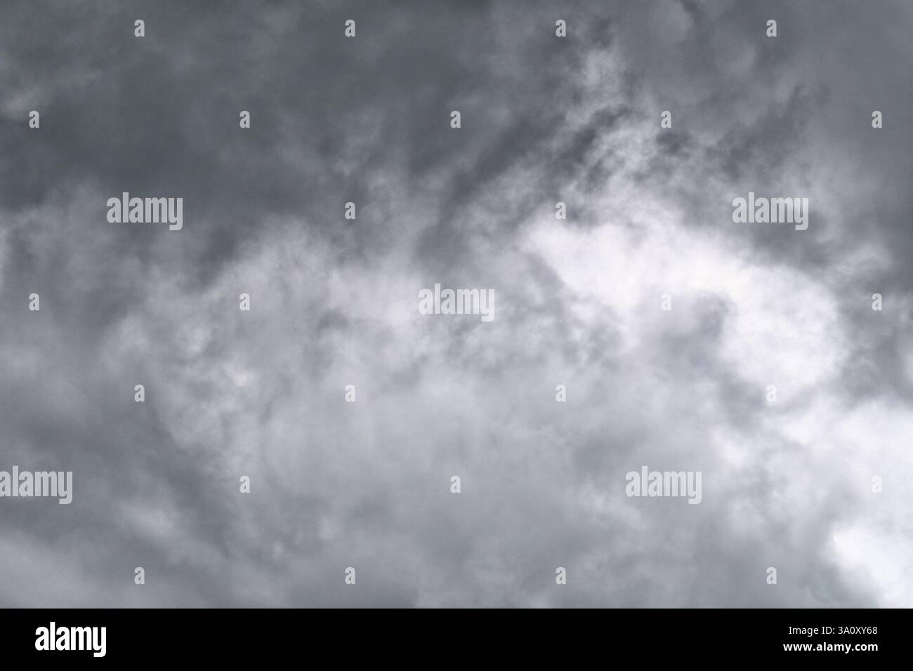 A cinematic view of a gray sky filled with swirling clouds, evoking a ...