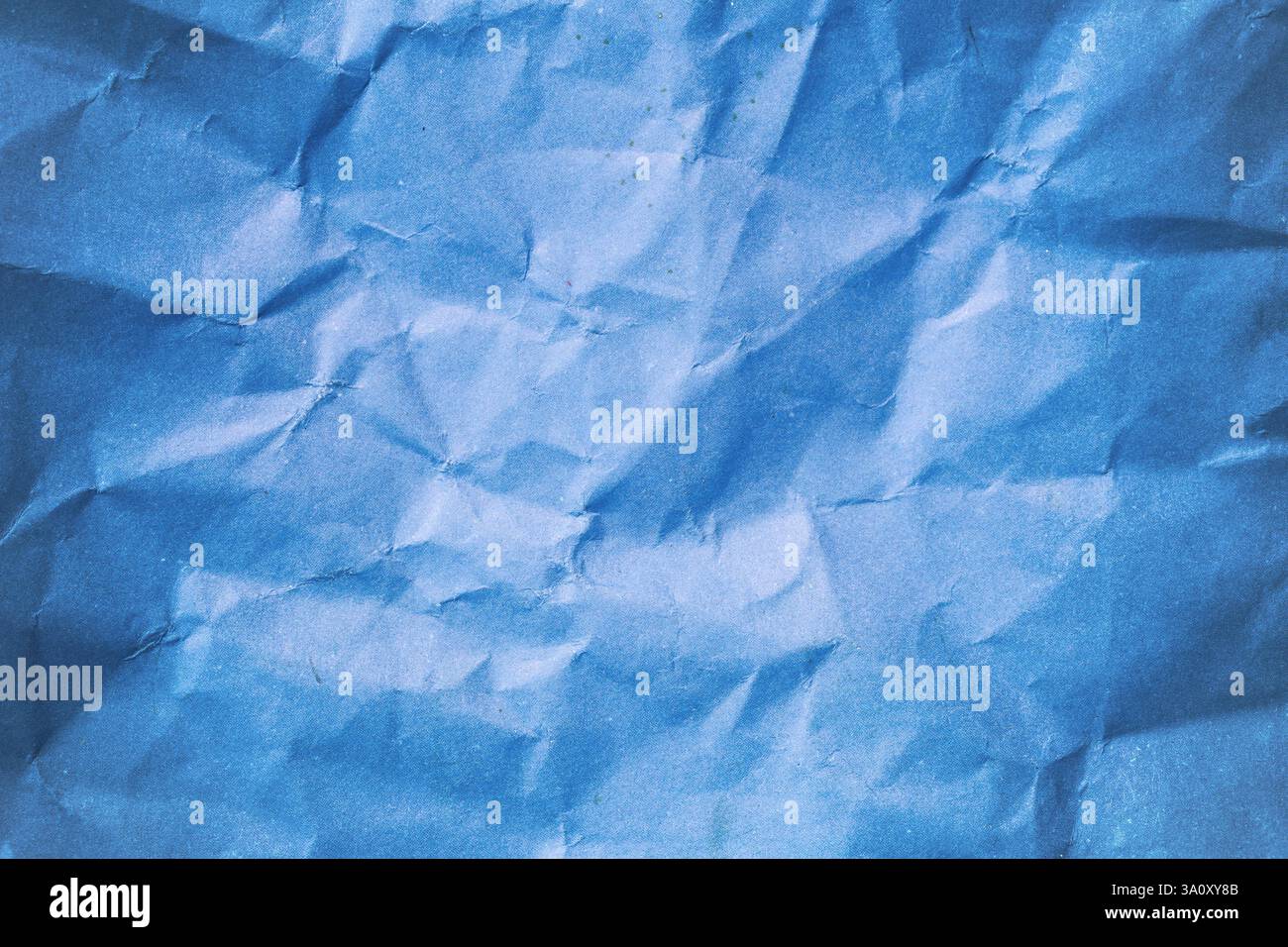 Close-up view of a crinkled blue paper texture that adds depth and ...