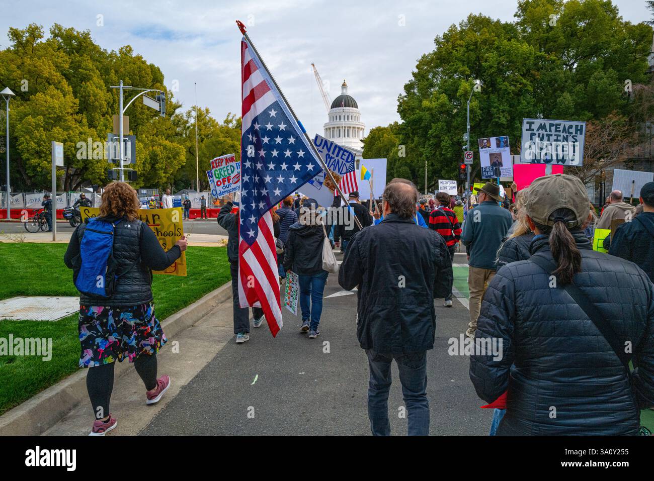 Sacramento, CA U.S.A. - Mar. 4, 2025: A man with an upside-down U.S ...