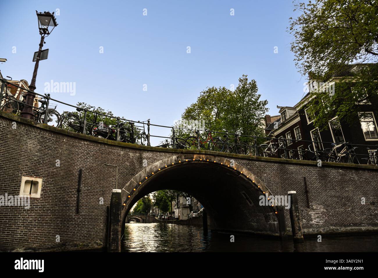 Classic Brick Bridge Over a Canal in Amsterdam - Netherlands Stock ...