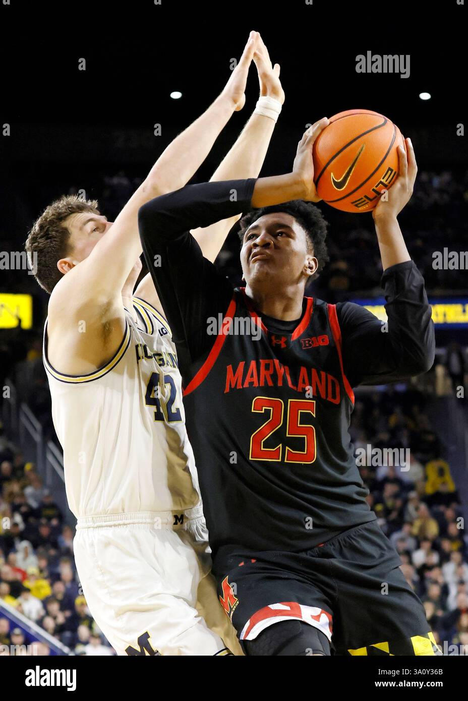 Maryland center Derik Queen (25) takes a shot against Michigan forward ...