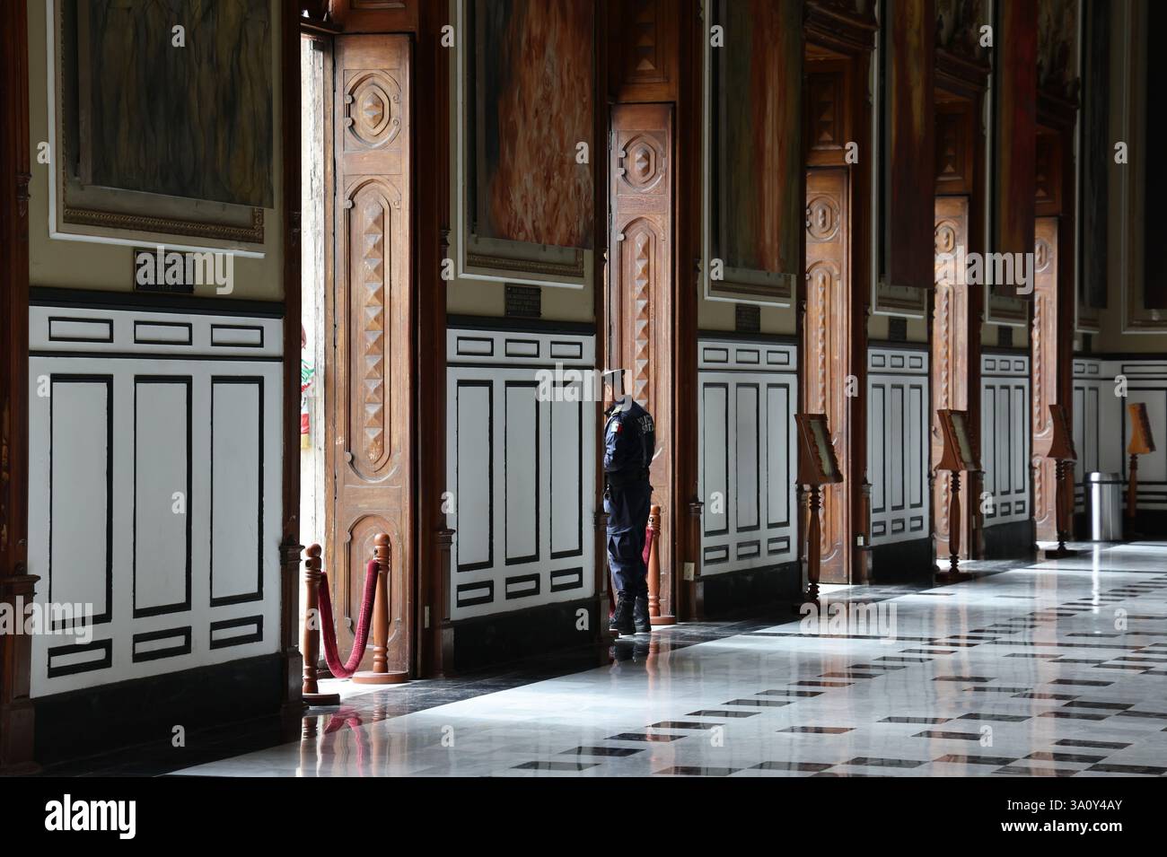 Mexican state police officer standing in a beautiful colonial building ...