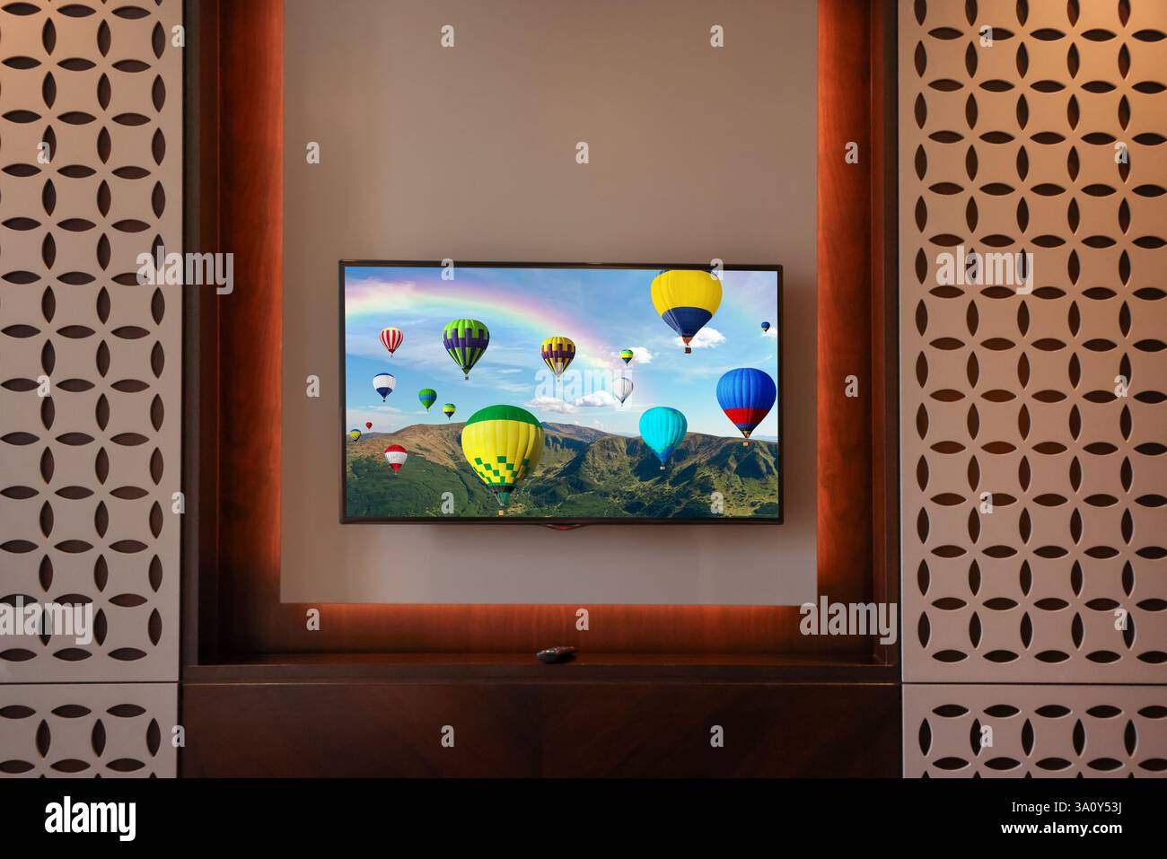 TV set with hot air balloons floating over mountains on screen in room ...