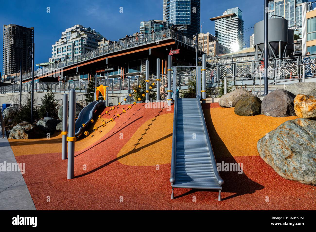 Mini playground with slides and climbing features and rubber surface at ...