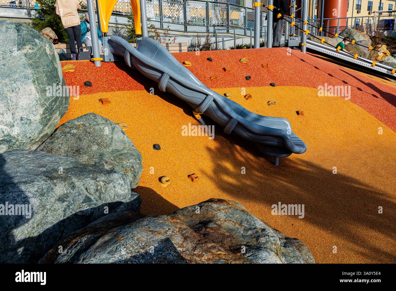 Mini playground with slides and climbing features and rubber surface at ...