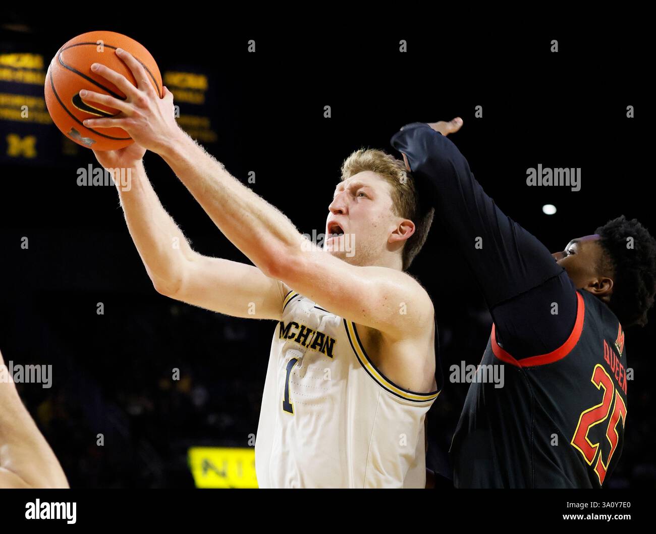 Michigan center Danny Wolf (1) goes to the basket past Maryland center ...