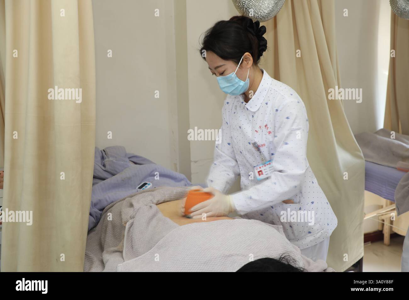 YANCHENG, CHINA - MARCH 6, 2025 - A woman experiences TCM appropriate ...