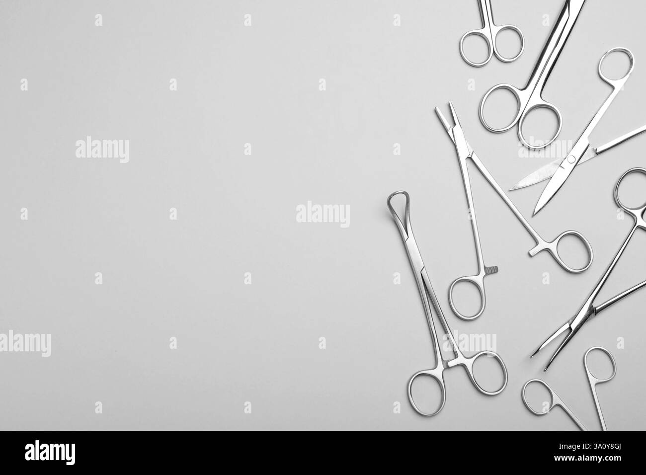 Different surgical instruments on grey background, flat lay. Space for ...
