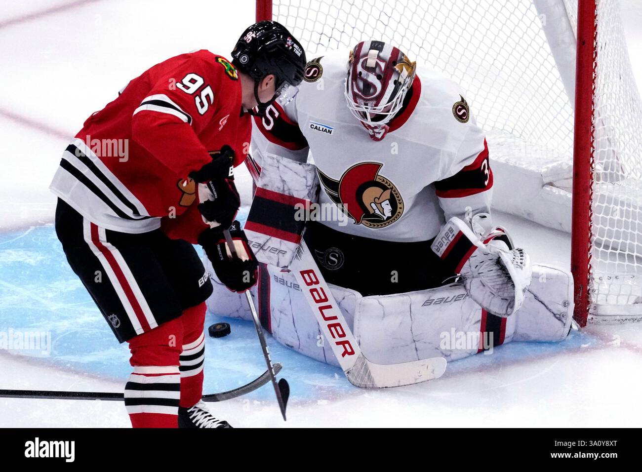 Ottawa Senators goaltender Linus Ullmark, right, saves a shot by ...