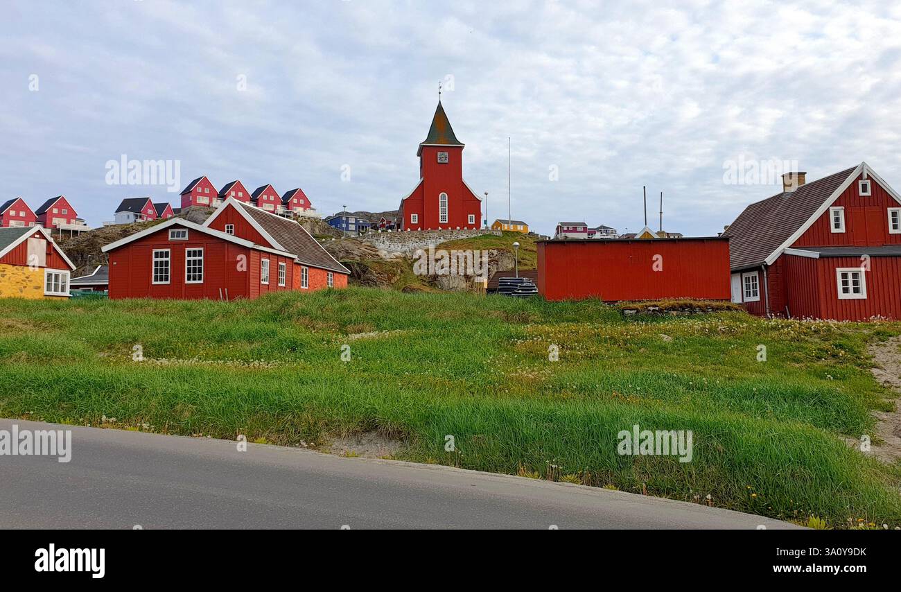 Scenic view of the church and traditional Inuit residences in bright ...