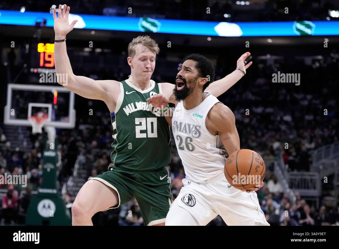 Dallas Mavericks' Spencer Dinwiddie tries to get [ast Milwaukee Bucks ...