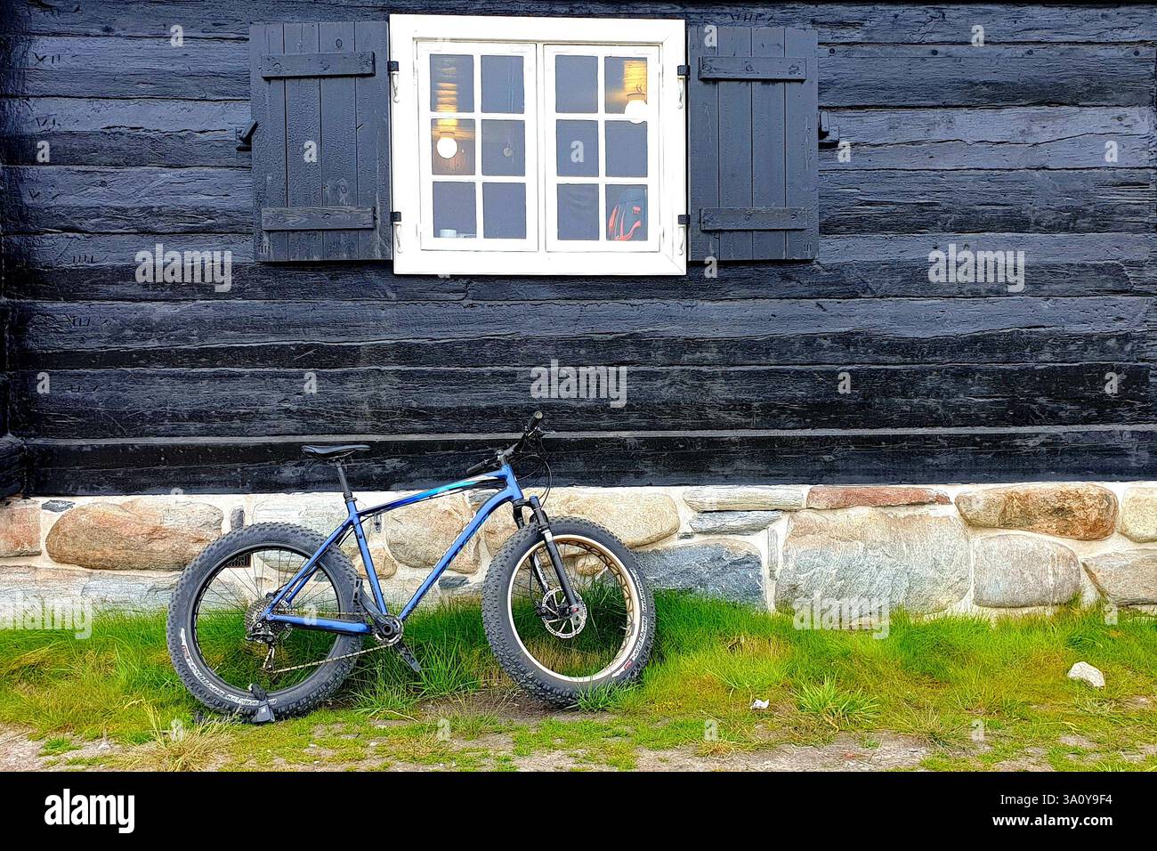 Old mountain bike against the black wall of a wooden house in Greenland Stock Photo - Alamy