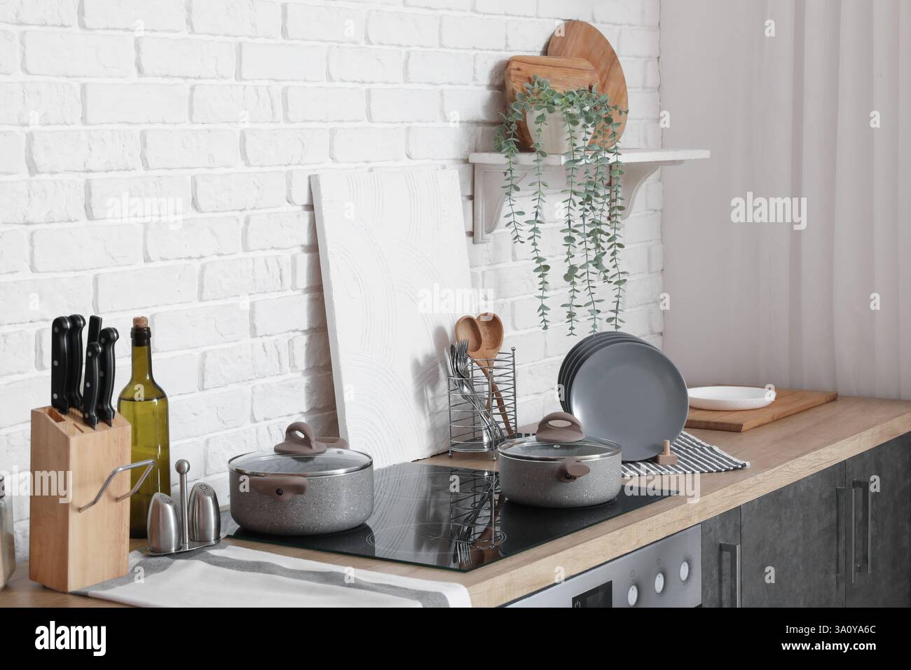 Wooden counters with plate rack, cutting board, utensils and electric ...