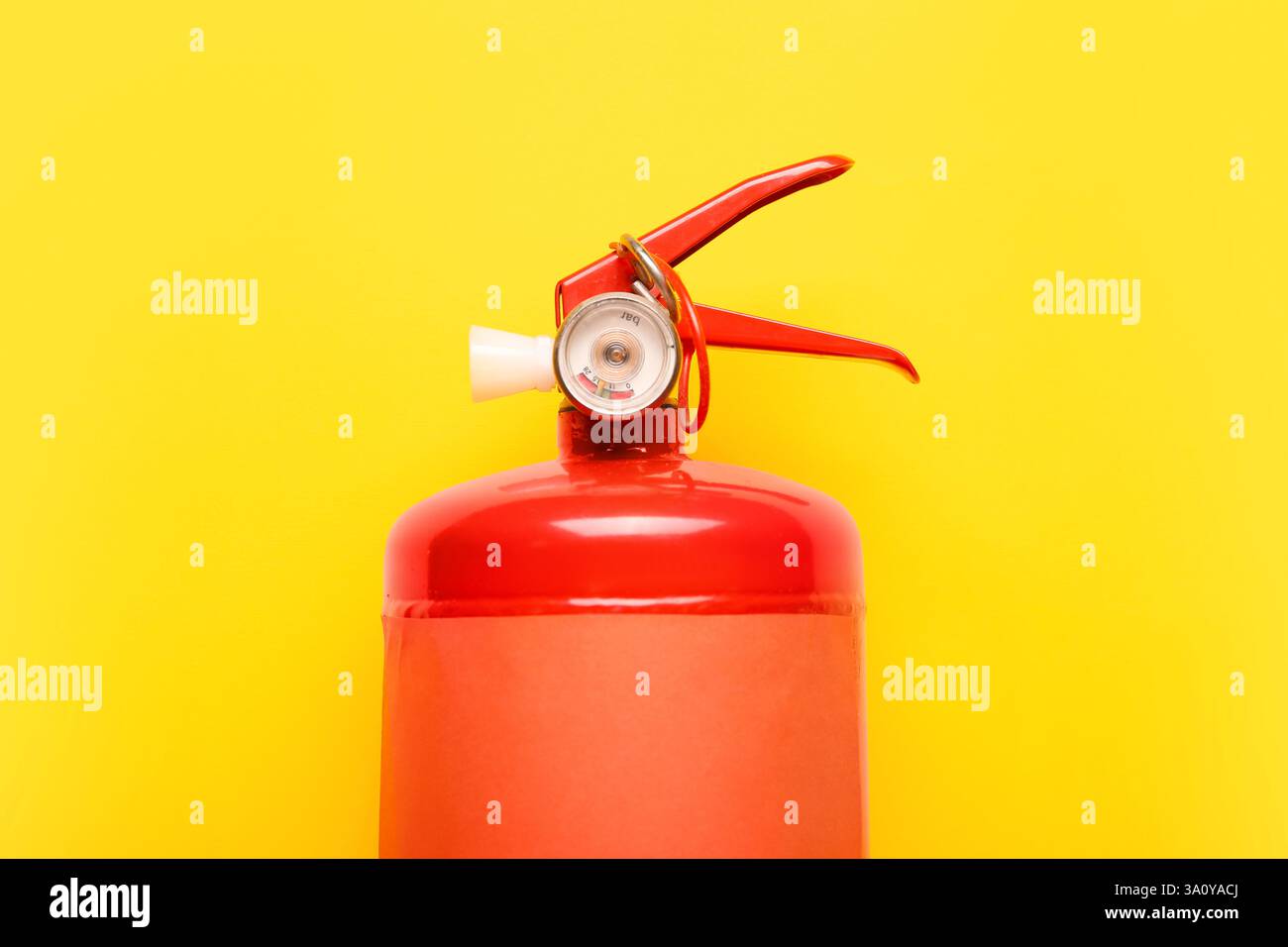 Fire extinguisher on yellow background Stock Photo - Alamy