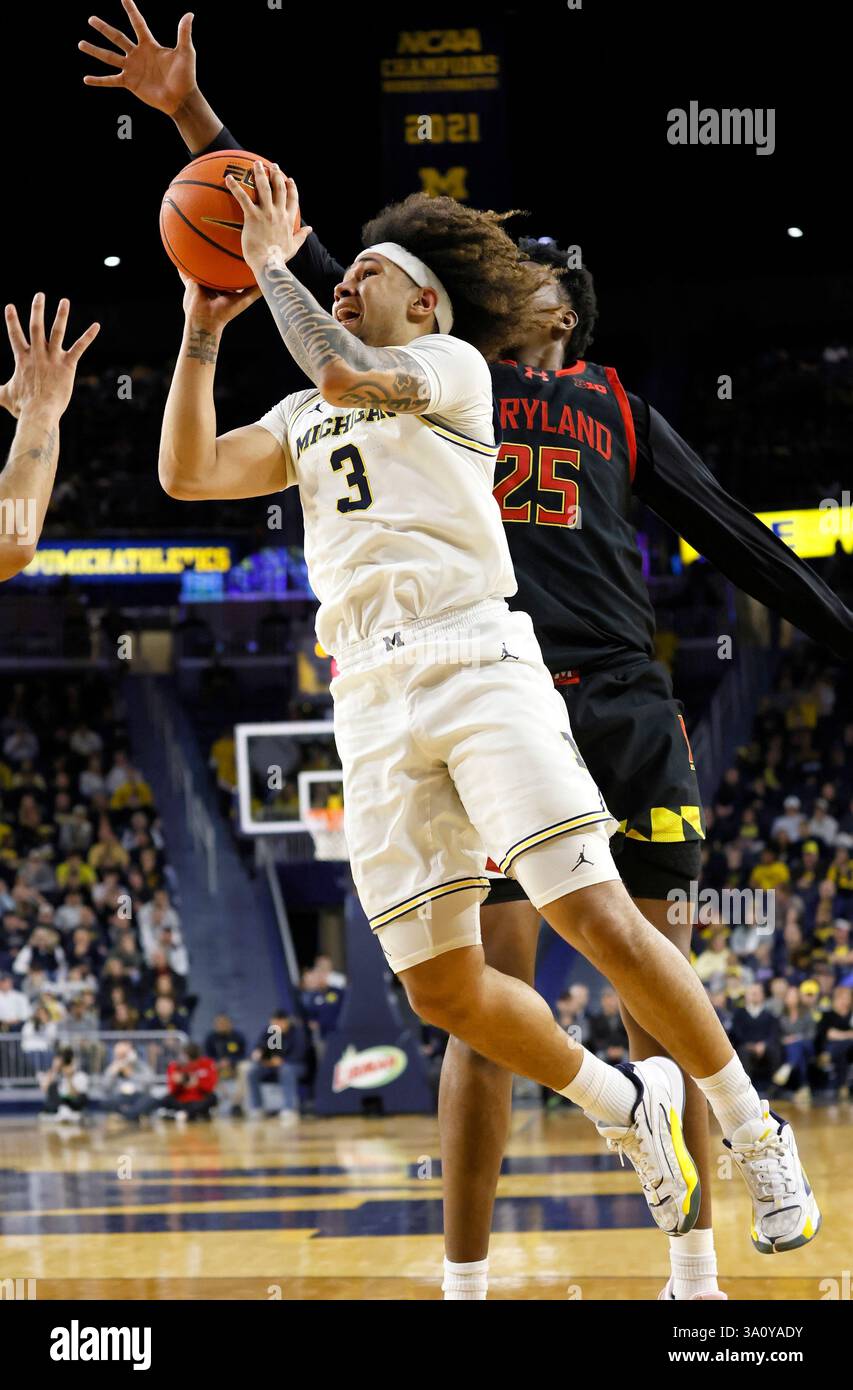 Michigan guard Tre Donaldson (3) goes to the basket past Maryland ...