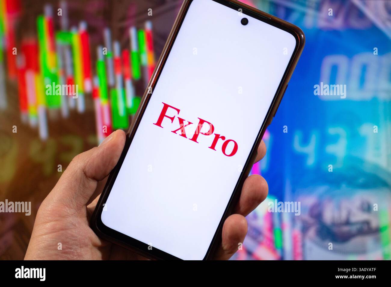 BOGOTA, COLOMBIA - MARCH 05 OF 2025 a male left hand with fxpro stock exchange logo inside a ...