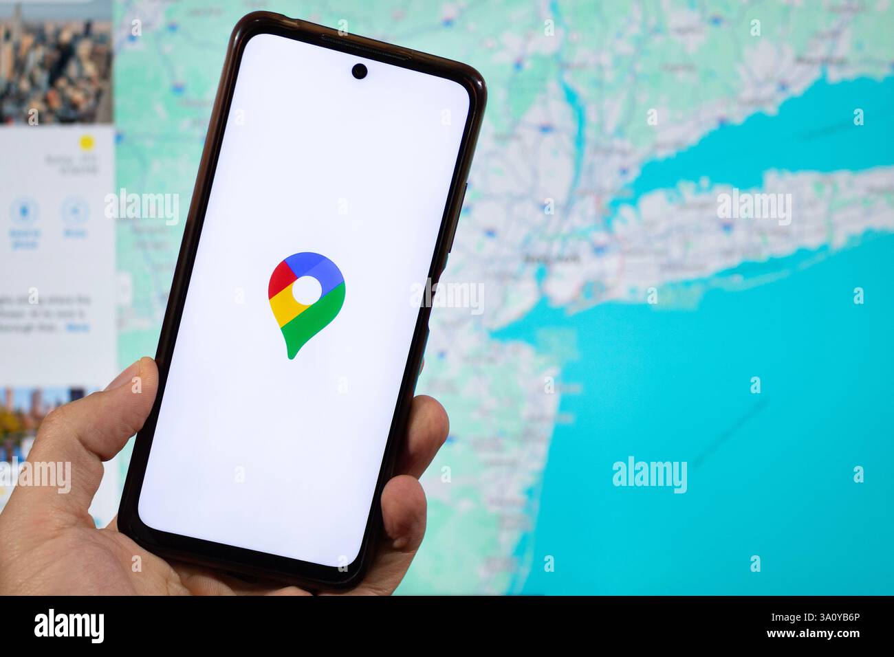 BOGOTA, COLOMBIA - MARCH 05 OF 2025 closeup to a male hand with google maps symbol inside a ...