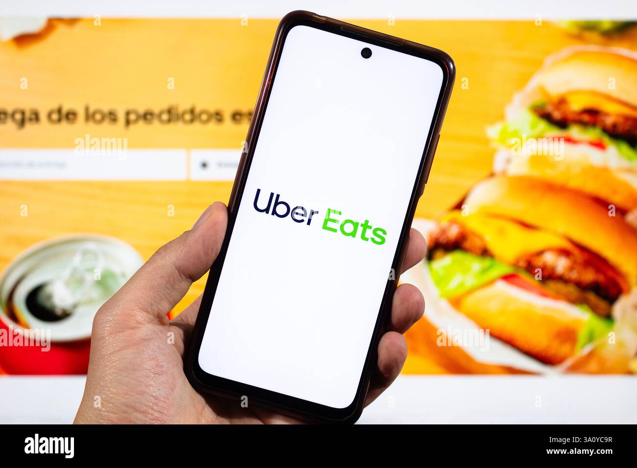 BOGOTA, COLOMBIA - MARCH 05 OF 2025 A male hand holding a smartphone with his left hand and uber ...