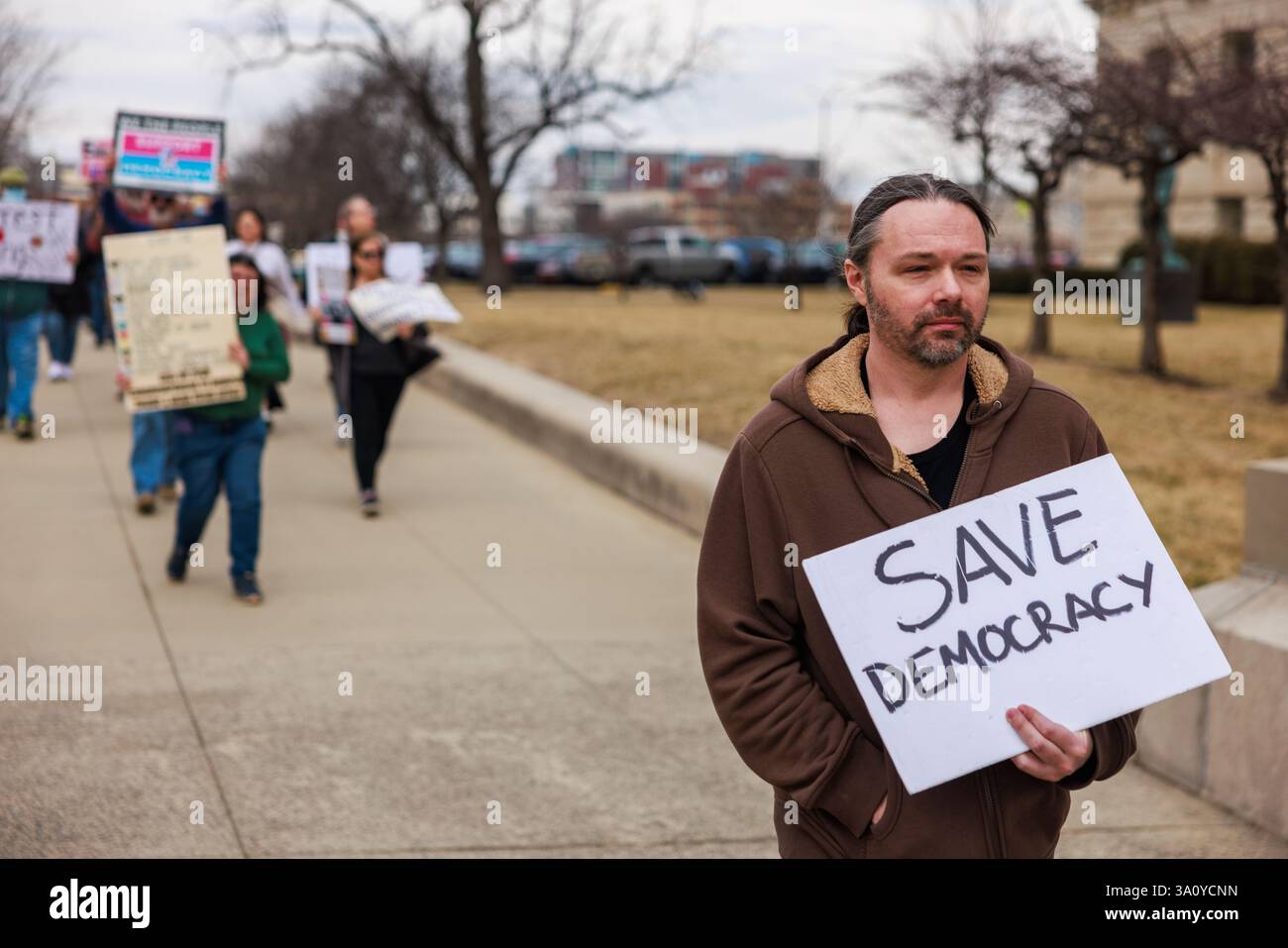 A protester holds a sign reading “Save Democracy” during a ...