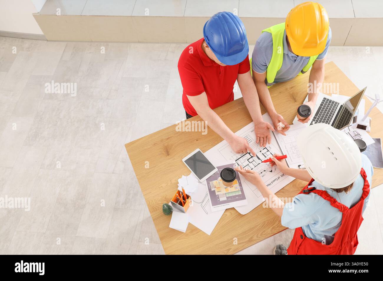 Team of constructors working with house plan at table in office, top ...