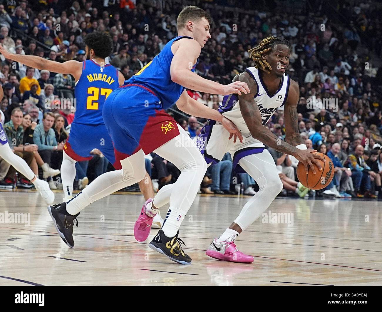 Sacramento Kings guard Keon Ellis, right, looks to pass the ball as ...