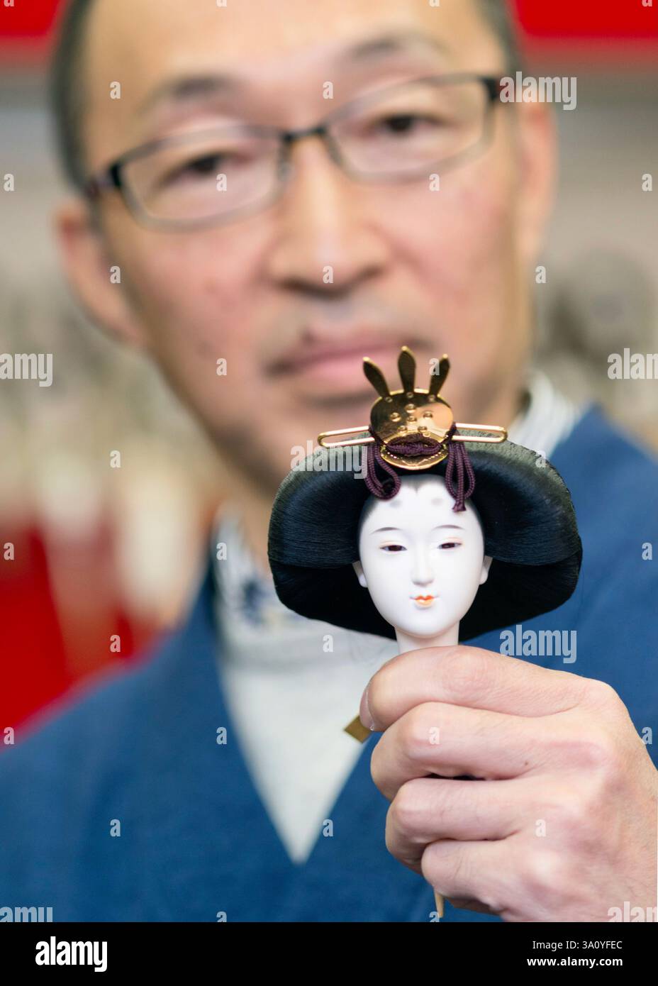 Hiroshi Omamiuda holds the heads of two Iwatsuki ningyo Dolls that are ...