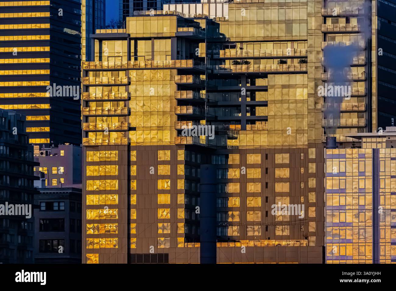 Waterfront buildings reflecting winter sunset in Seattle, Washington ...