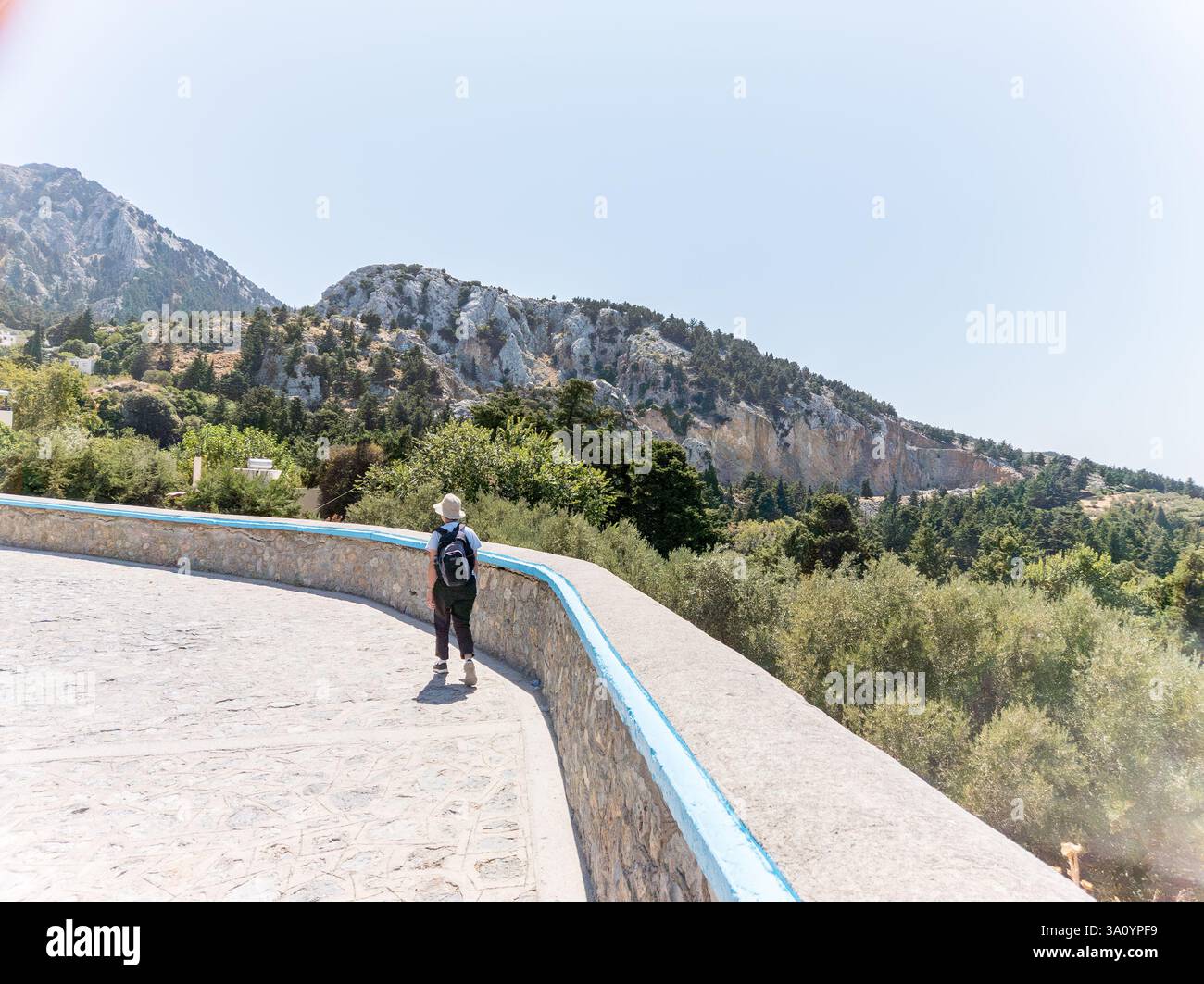 Zia Greece - August 25 2024; Stone cliffs rise sharply behind the ...