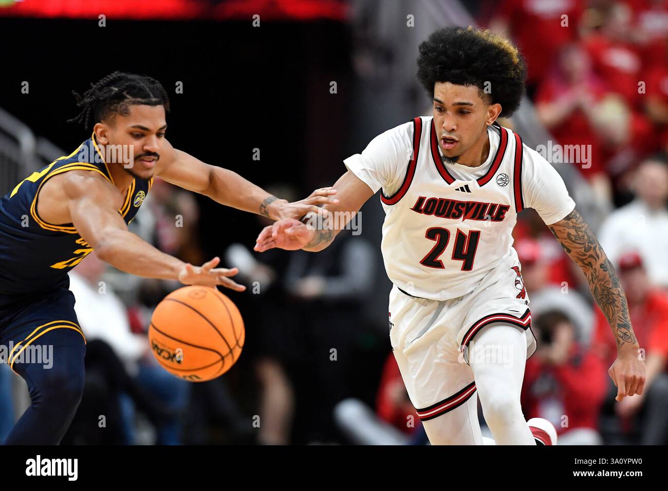 Louisville guard Chucky Hepburn (24) battles California guard Christian ...