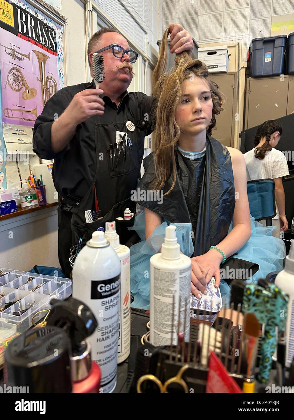 Hollywood hair stylist Randy Sayer, left, styles hair for Ella Warmer ...