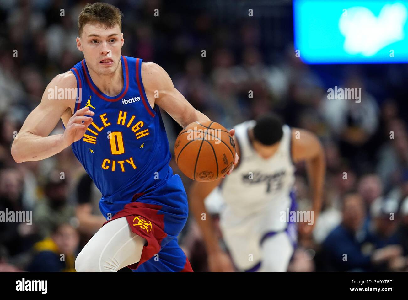 Denver Nuggets guard Christian Braun, front, collects a loose ball in ...