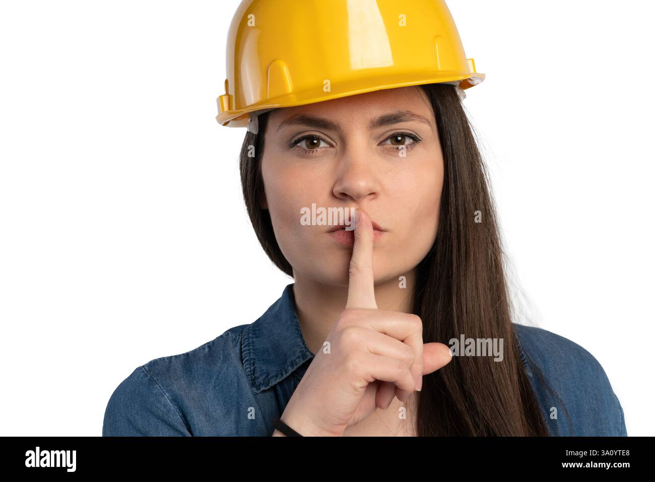 Serious woman signaling shh gesture hi-res stock photography and images ...