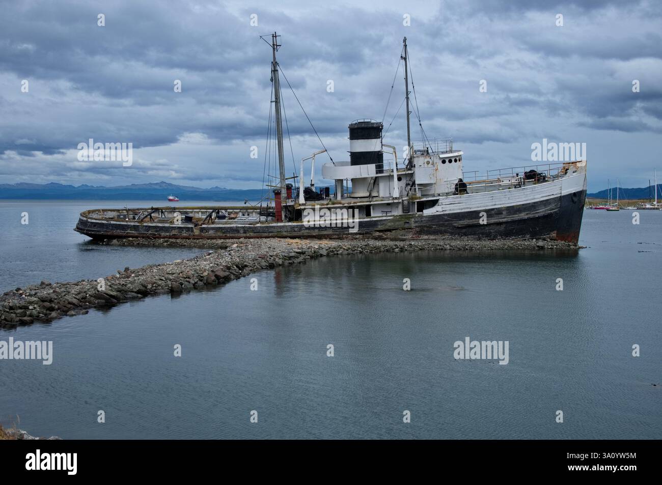 Wrecked ship on the stone pier Stock Photo - Alamy