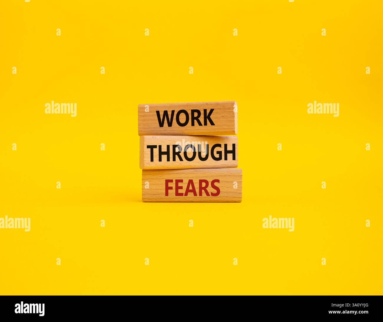 Work through fears symbol. Wooden blocks with words Work through fears ...