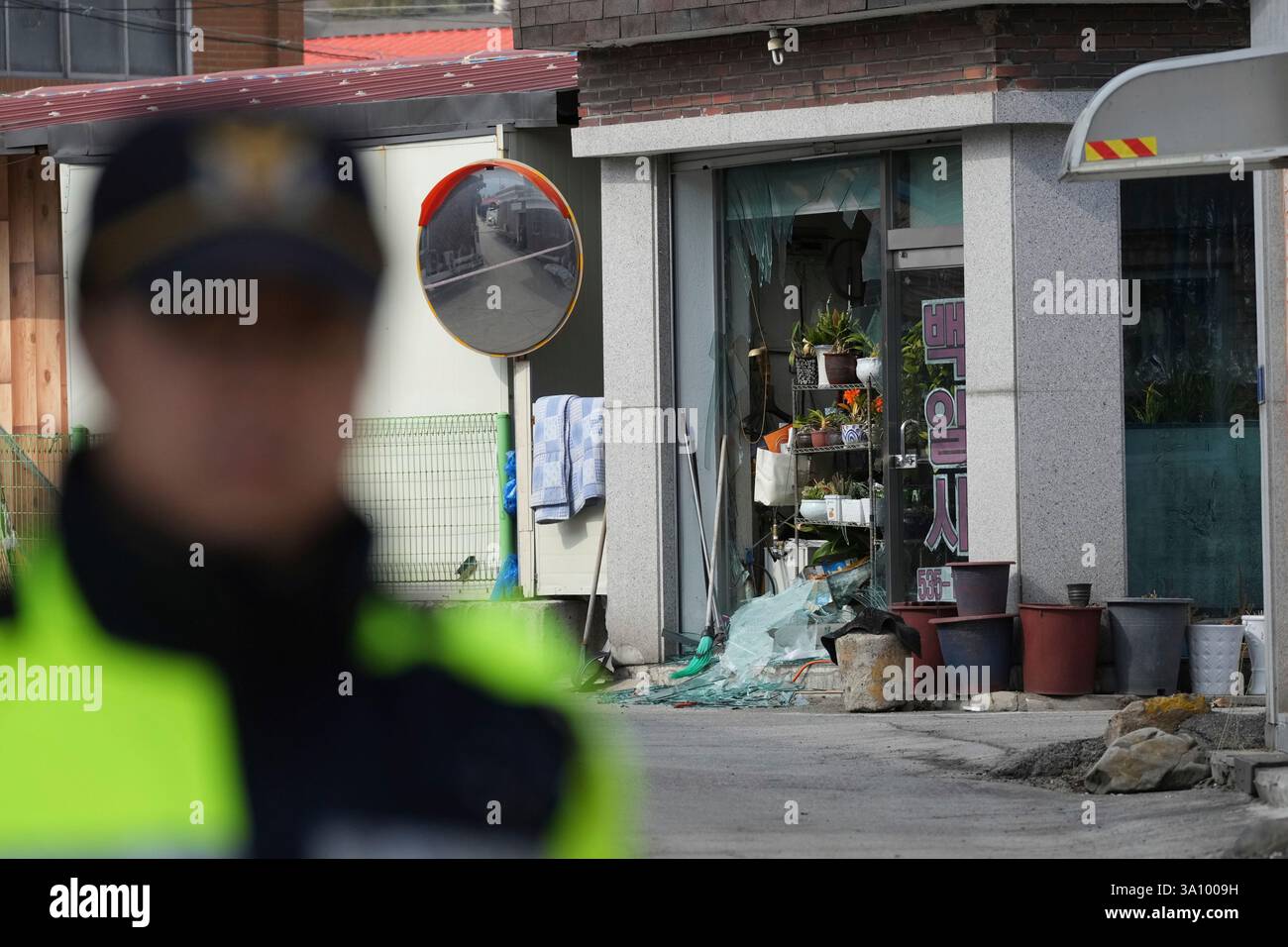 A police officer controls damaged area near the site of an accidental ...