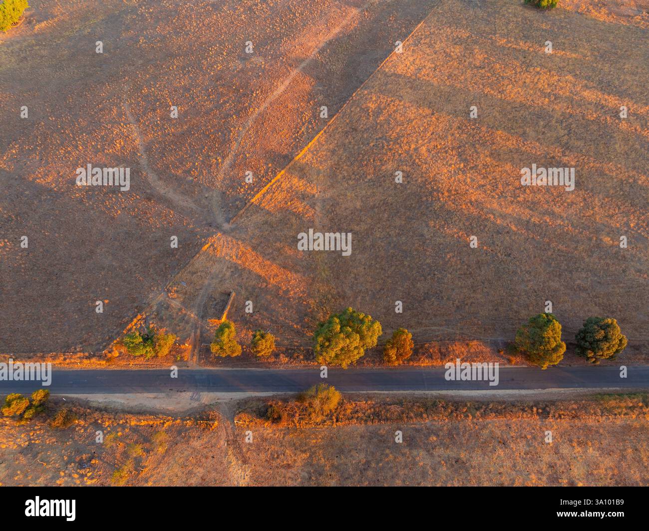 Aerial view of a country road below a dry rural hillside at Guildford ...