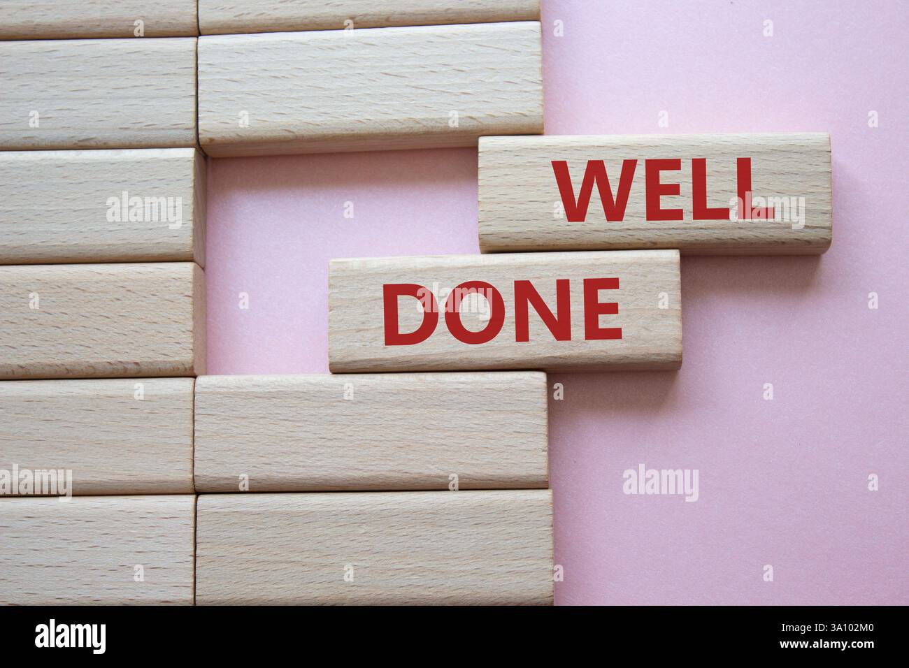 Well done symbol. Wooden blocks with words Well done. Beautiful pink ...