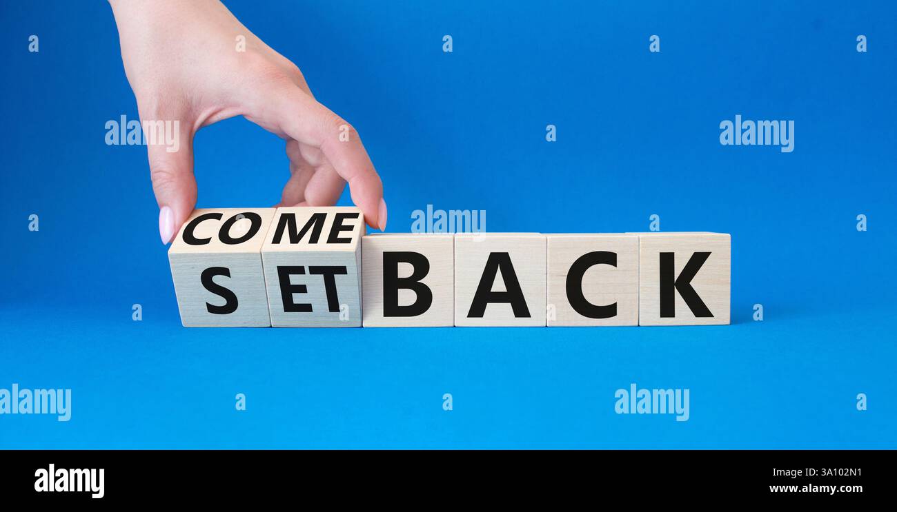 Comeback and setback symbol. Hand turns a cube and changes the word ...