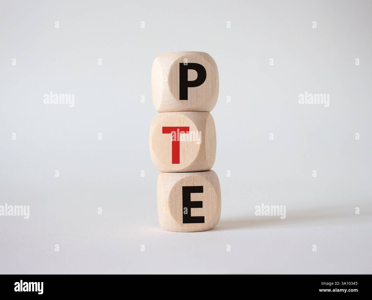 PTE - Pearson Tests of English symbol. Wooden cubes with word PTE ...